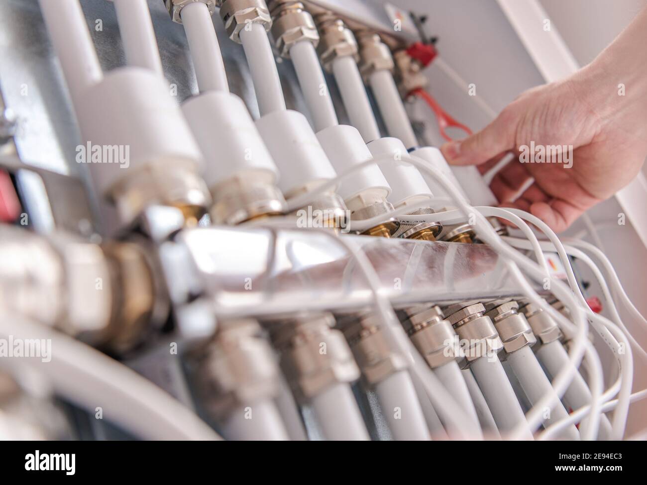 Modern Home Water Heating Valves Adjusting by Caucasian Men. Row of ...