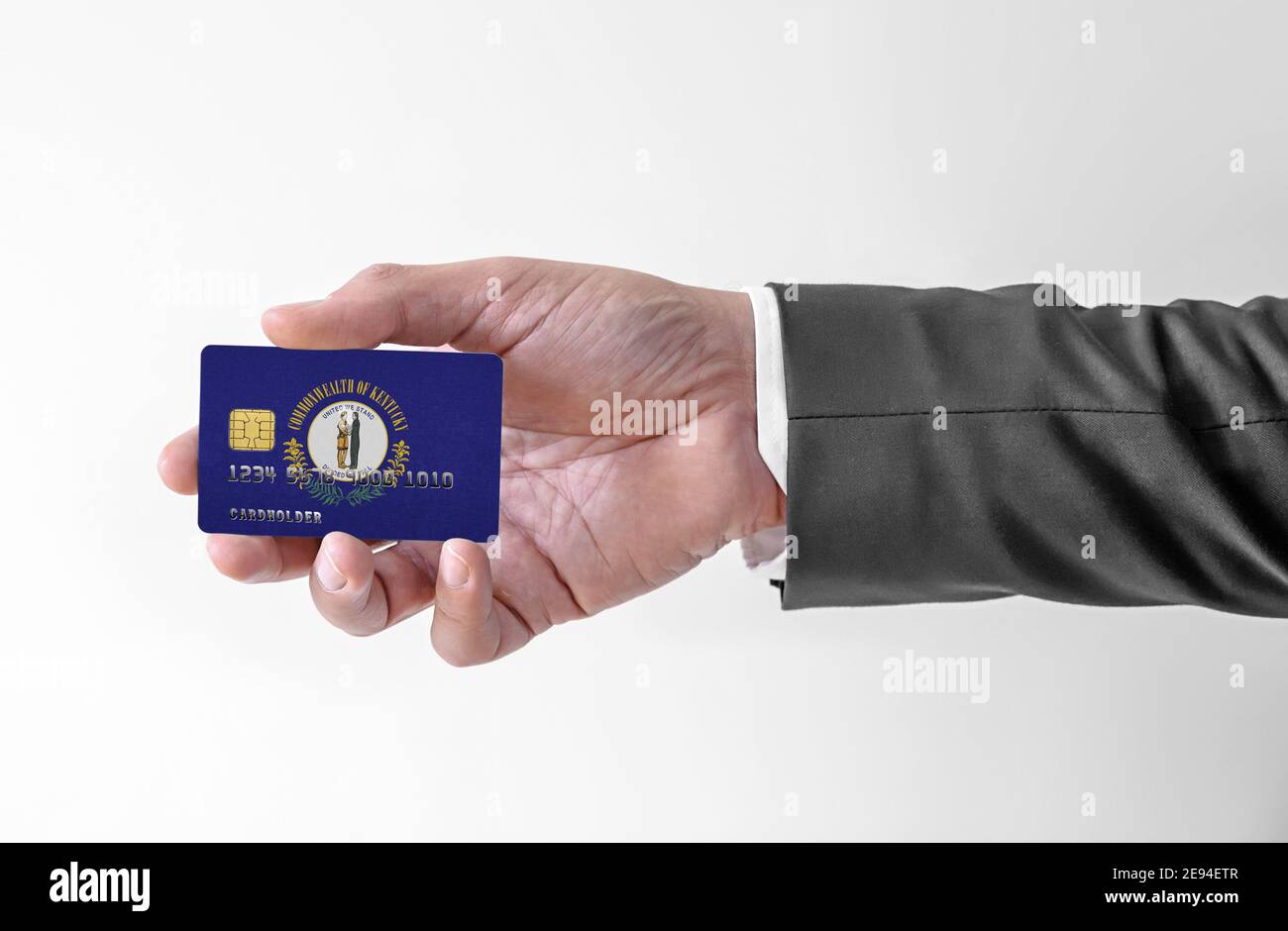 Bank credit plastic card with flag of USA state Kentucky holding man in ...
