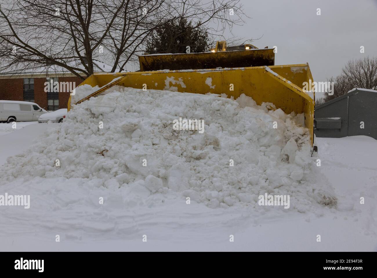 Snow clearing tractor clears the way after heavy snowfall for vehicle ...