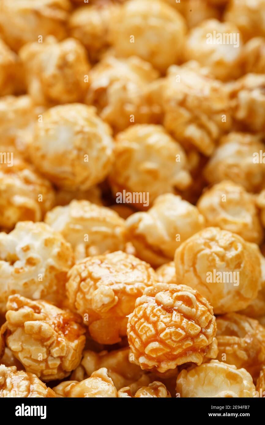 Popcorn in caramel glaze close-up as a background. Delicious praise for ...