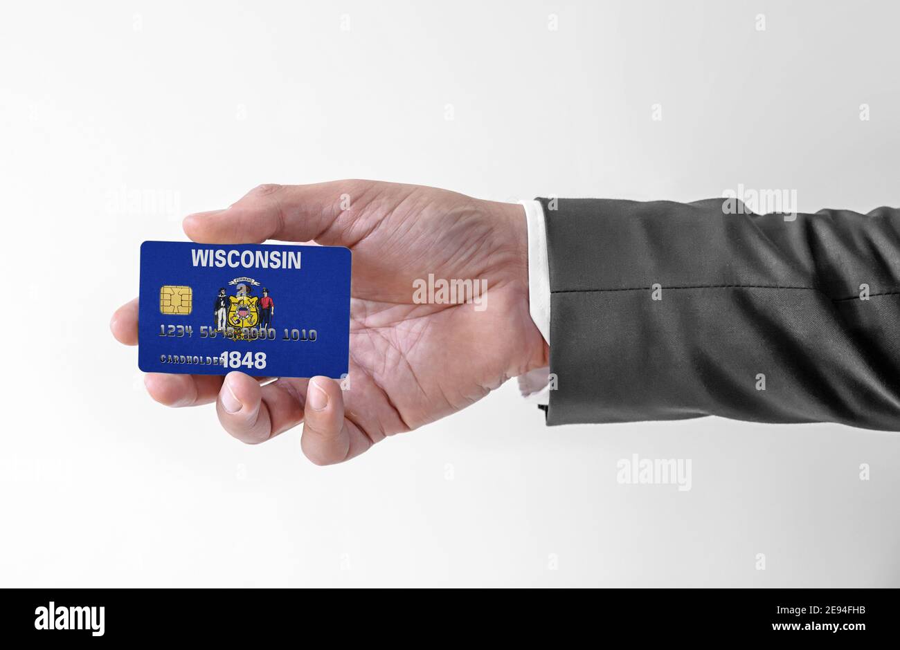 Bank credit plastic card with flag of USA state Wisconsin holding man ...