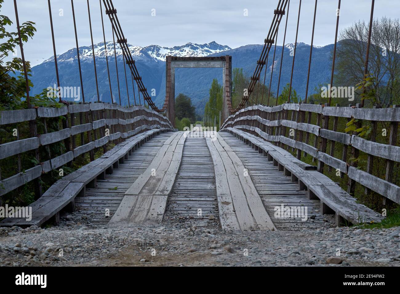 Old wooden suspension bridge connecting an isolated country road Stock ...