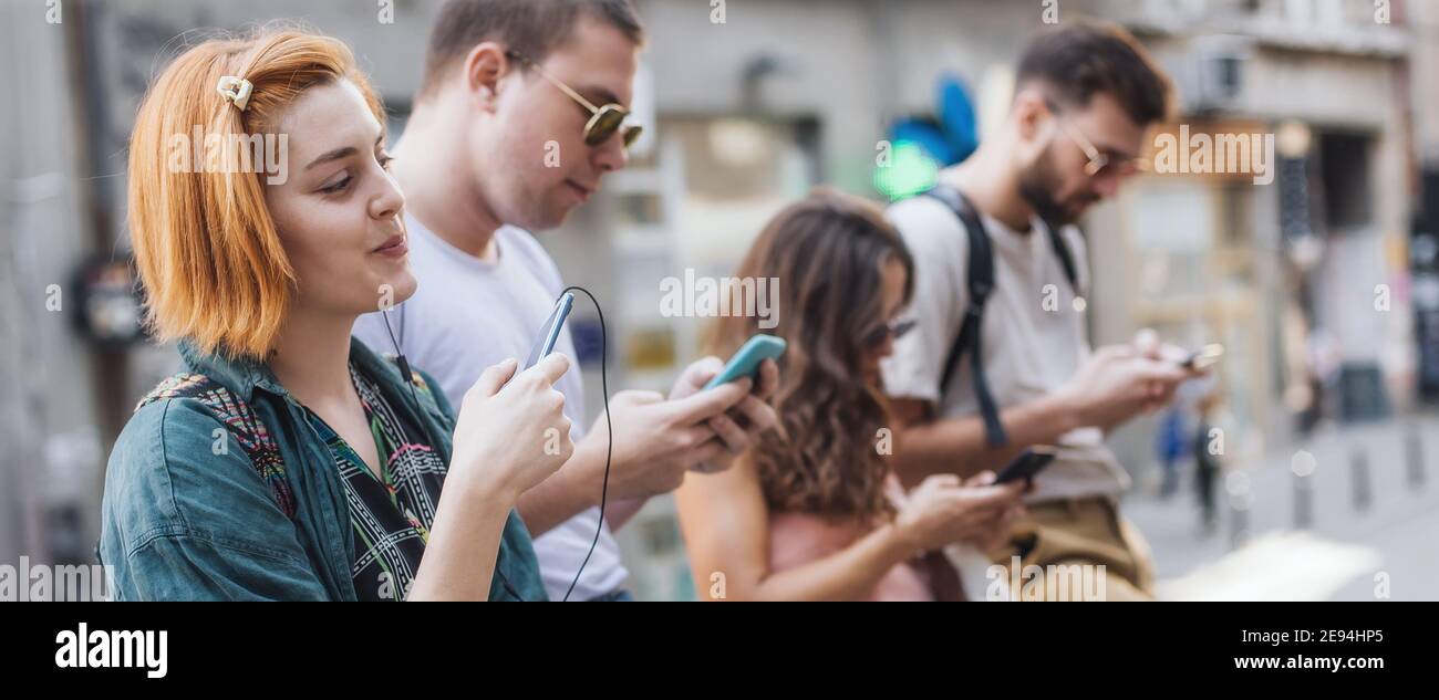 Group of friends using smartphones together. Young people addiction to ...