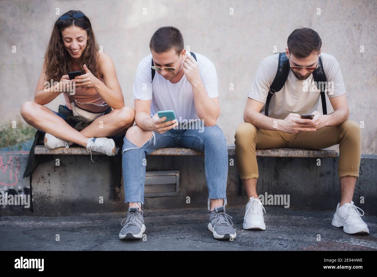 Group of friends using smartphones together. Young people addiction to ...