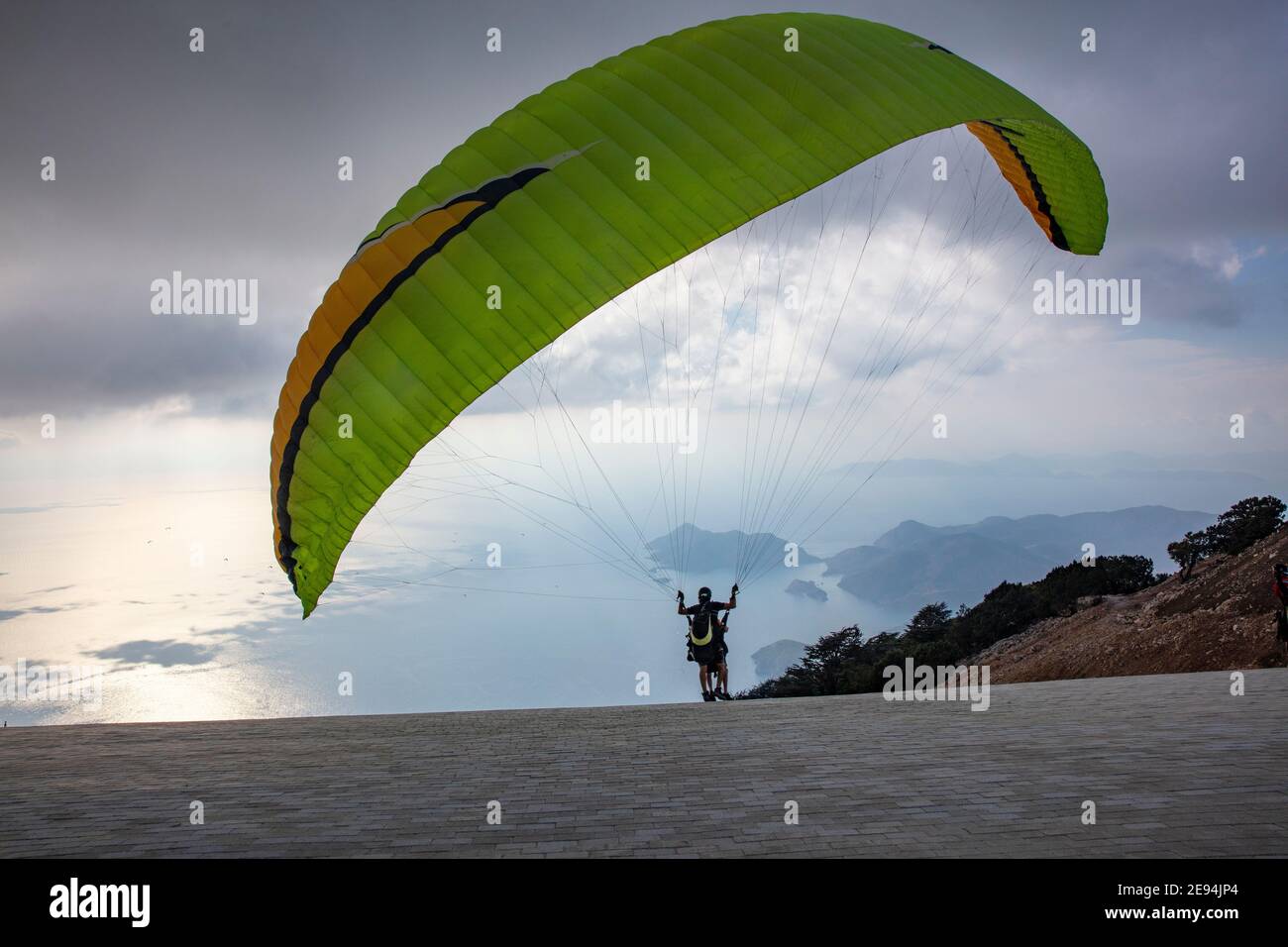 Paragliding in the sky. Paraglider tandem flying over the sea with ...