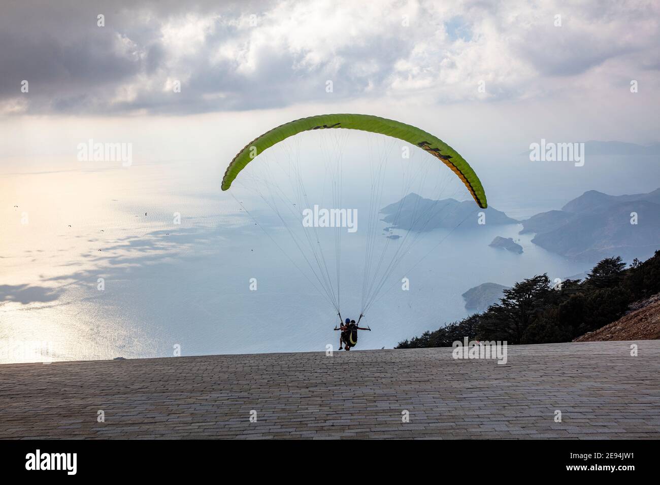 Paragliding in the sky. Paraglider tandem flying over the sea with ...