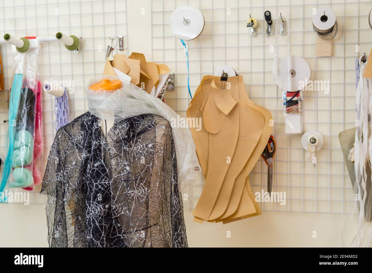Dressed mannequin and accessory wall in fashion design studio Stock ...