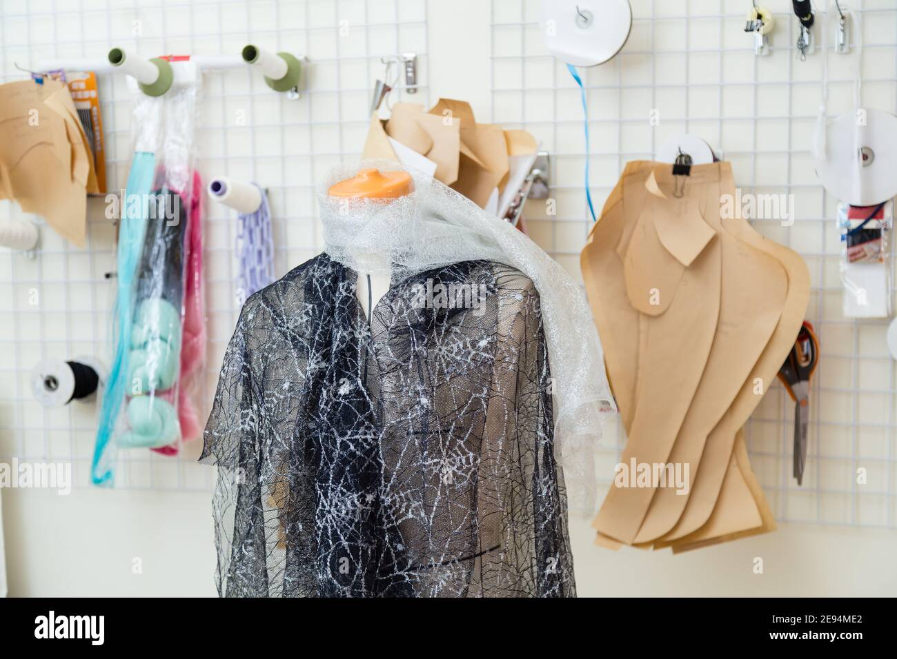 Dressed mannequin and accessory wall in fashion design studio Stock ...