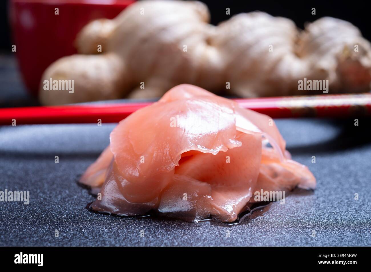 Asian food, pink sliced pickled ginger roots ready to eat, close up ...