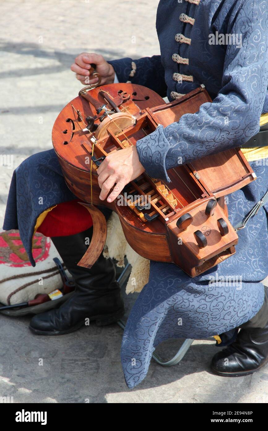 BUDAPEST, HUNGARY - JUNE 20, 2014: Street performer plays hurdy gurdy ...