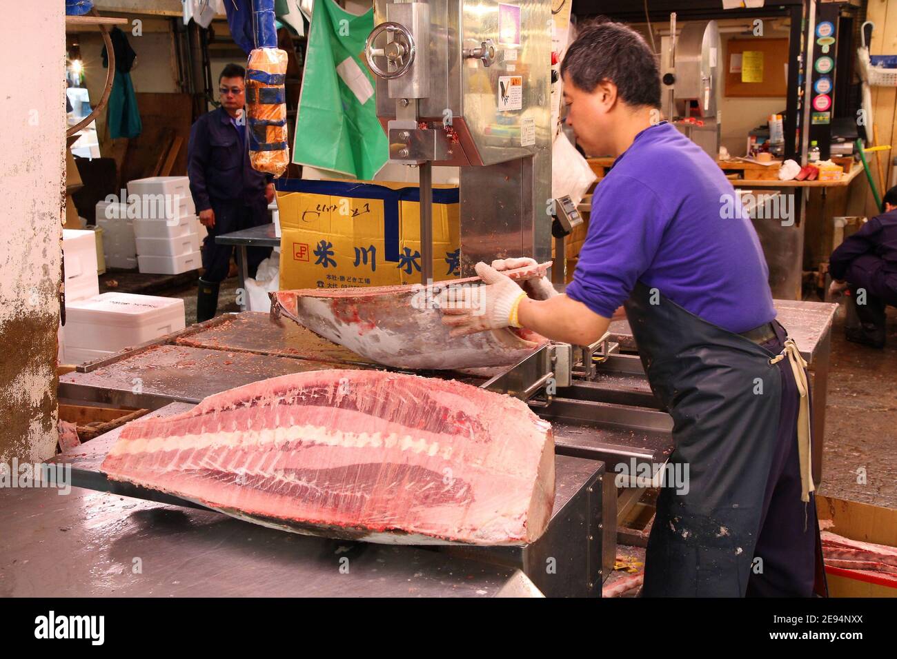 TOKYO, JAPAN - MAY 11, 2012: Vendor cuts huge frozen tuna fish at ...