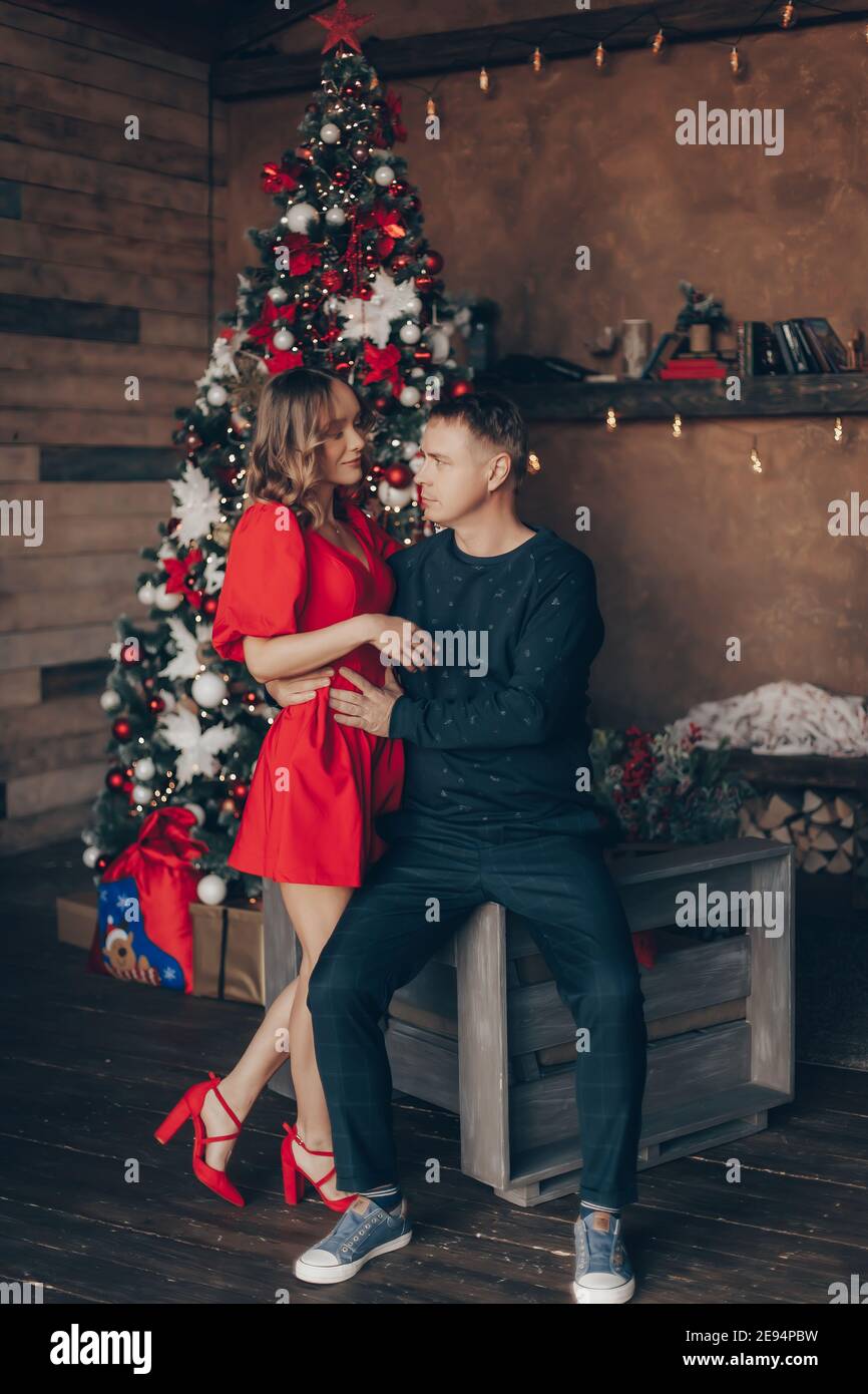 guy with a girl in the New Year's interior Stock Photo - Alamy