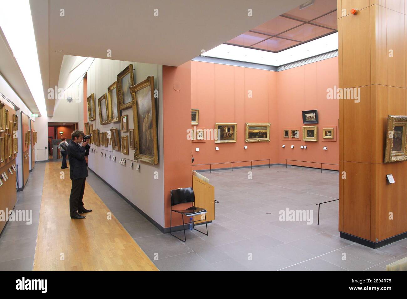 PARIS, FRANCE - JULY 22, 2011: Visitors admire paintings in Louvre ...
