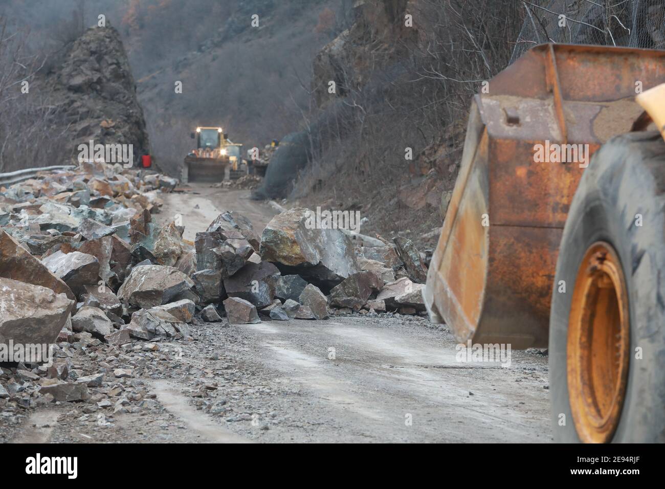 Heavy chain and wheeled equipment clears the highway after a rock ...