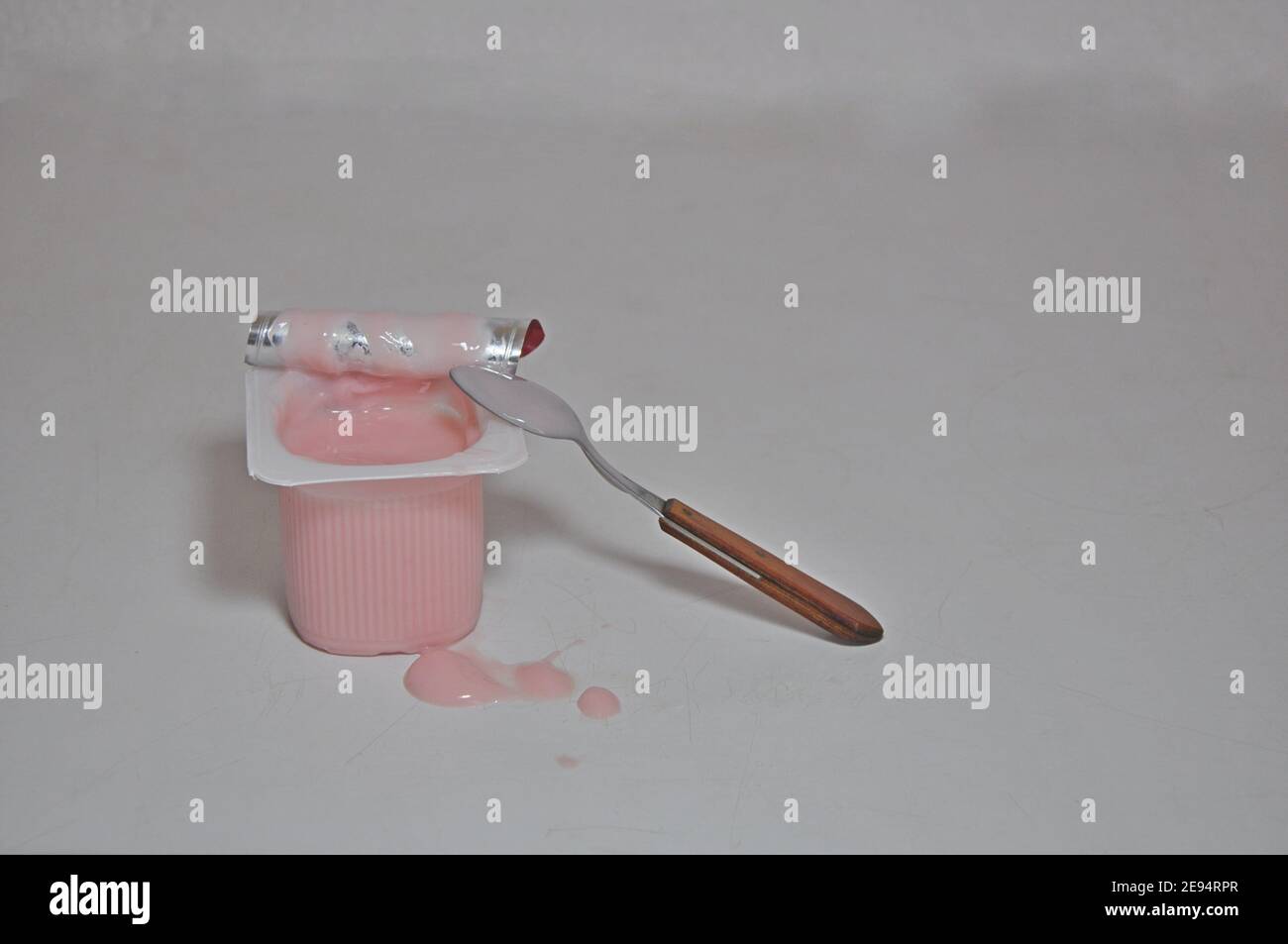 Plastic yogurt jar, strawberry-flavored open jar, with aluminum spoon ...