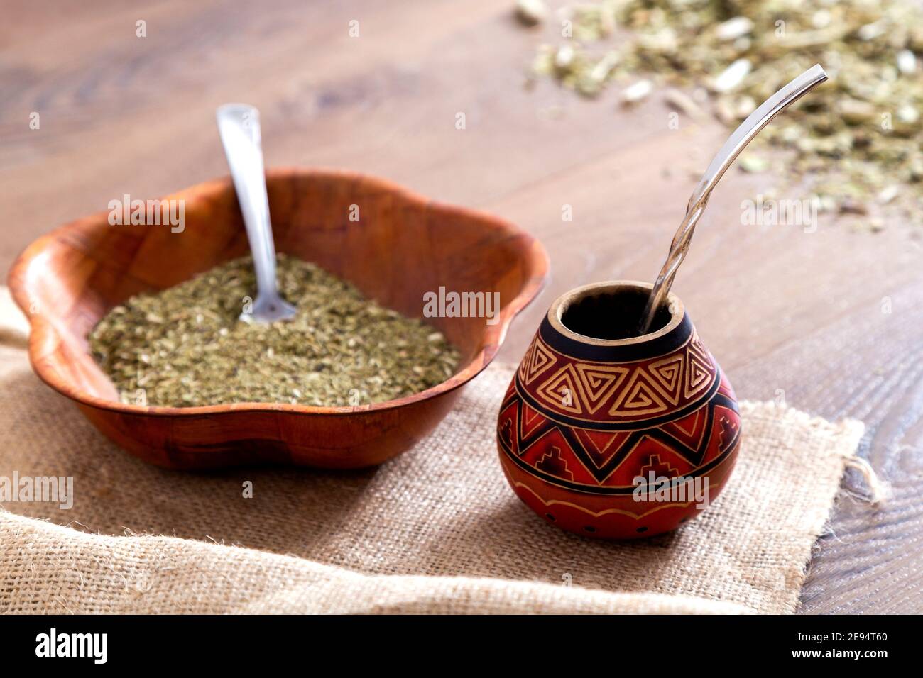 Traditional mate made of calabash over a wooden table with yerba mate ...