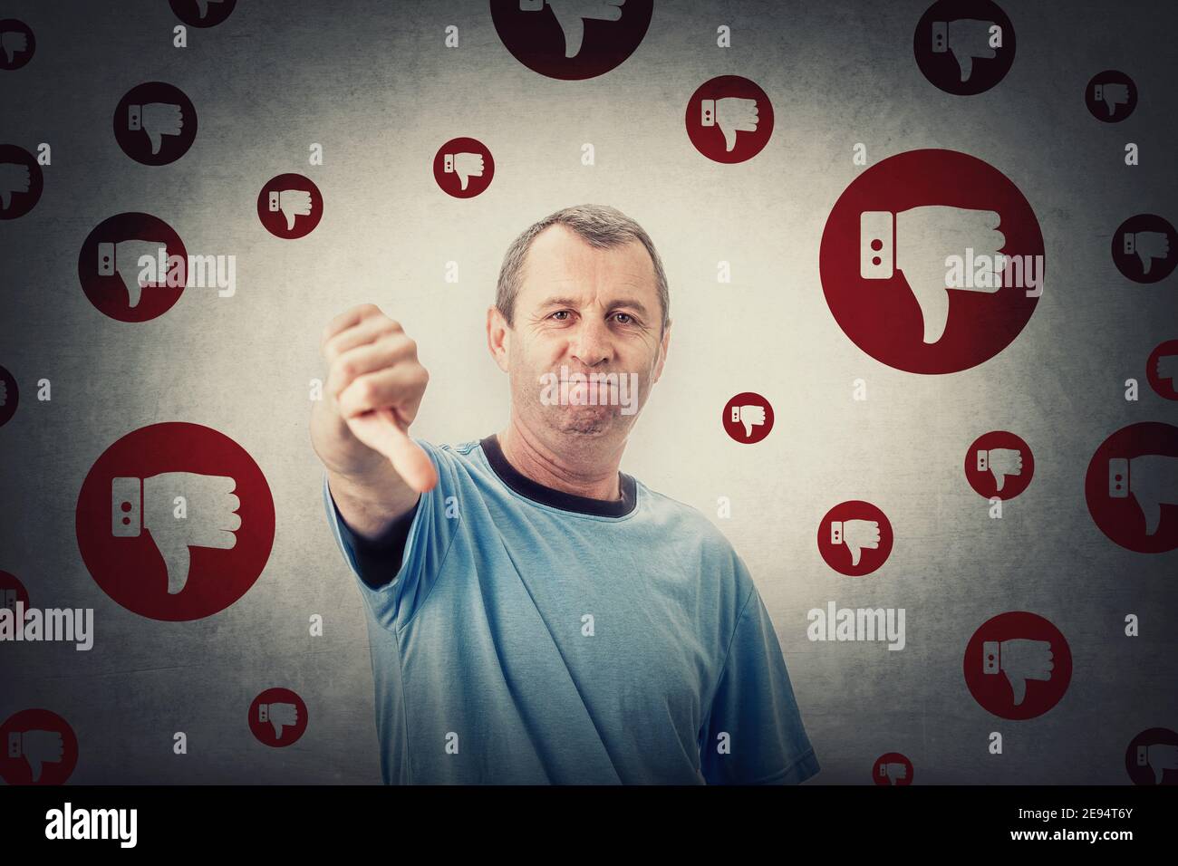 Displeased middle aged man shows thumbs down, negative gesture and bad ...