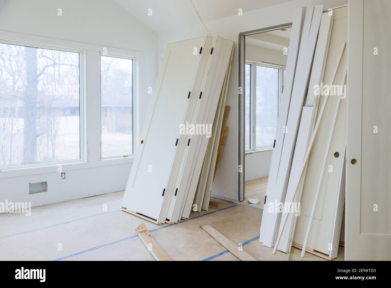 Interior wooden stacker door installation,apartment building, a wait ...