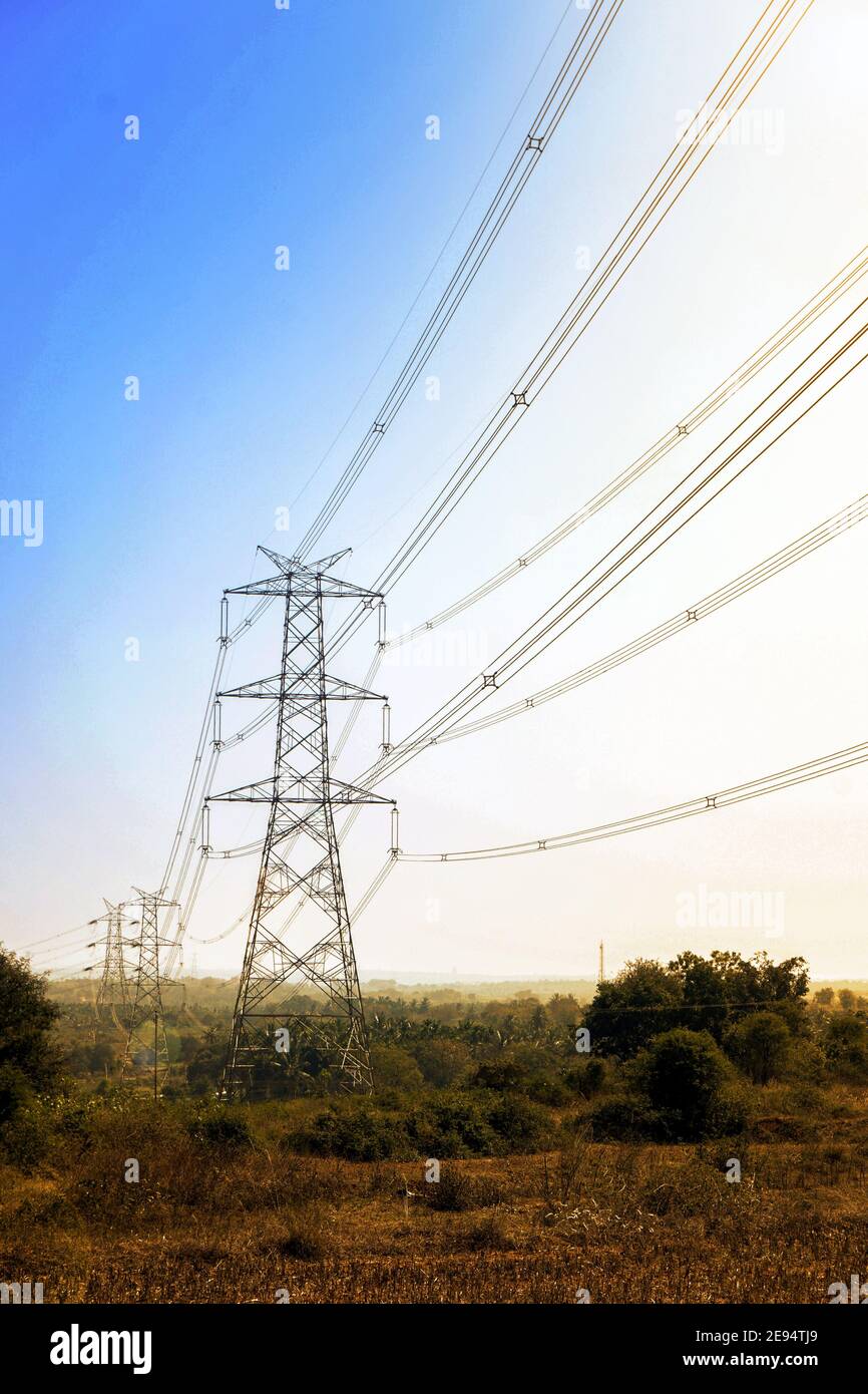 High voltage transmission towers line Stock Photo - Alamy