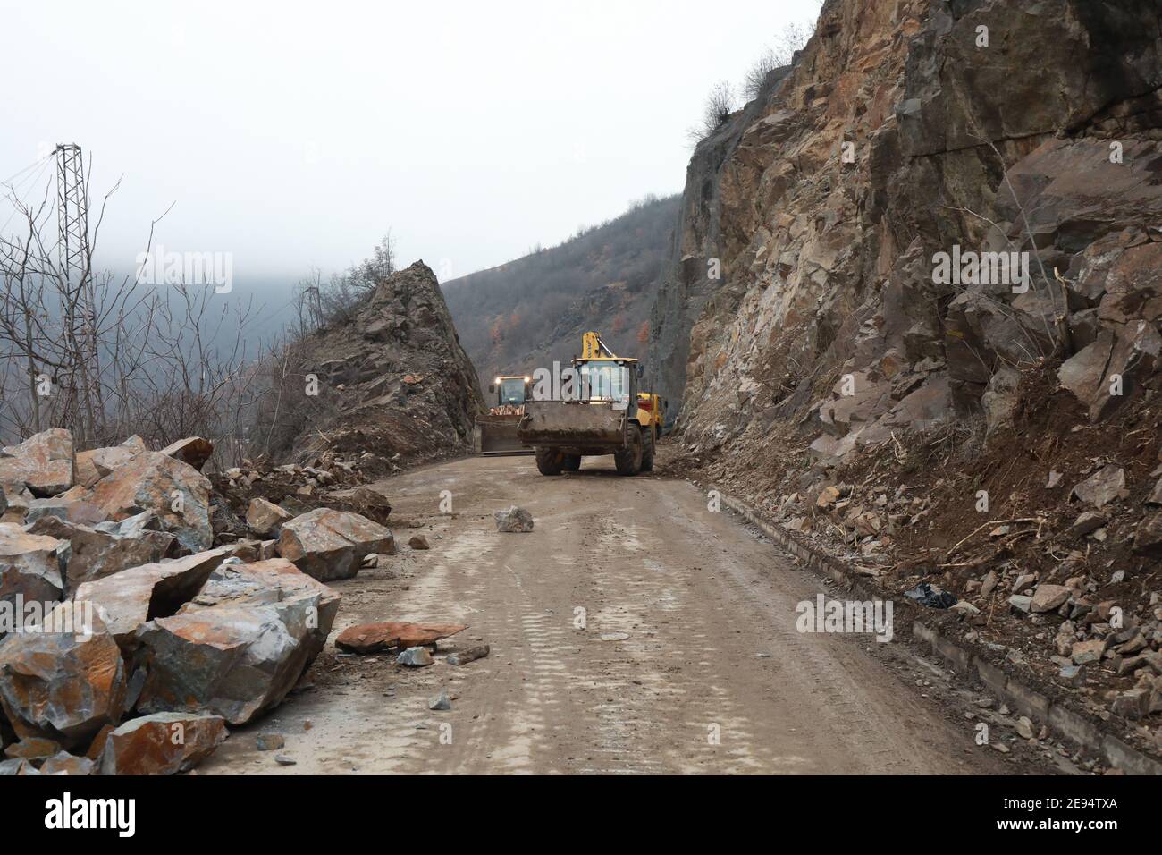 Heavy chain and wheeled equipment clears the highway after a rock ...