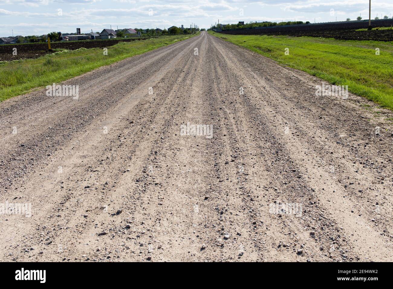 Dirt road leaving into the distance through the village. Rural ...