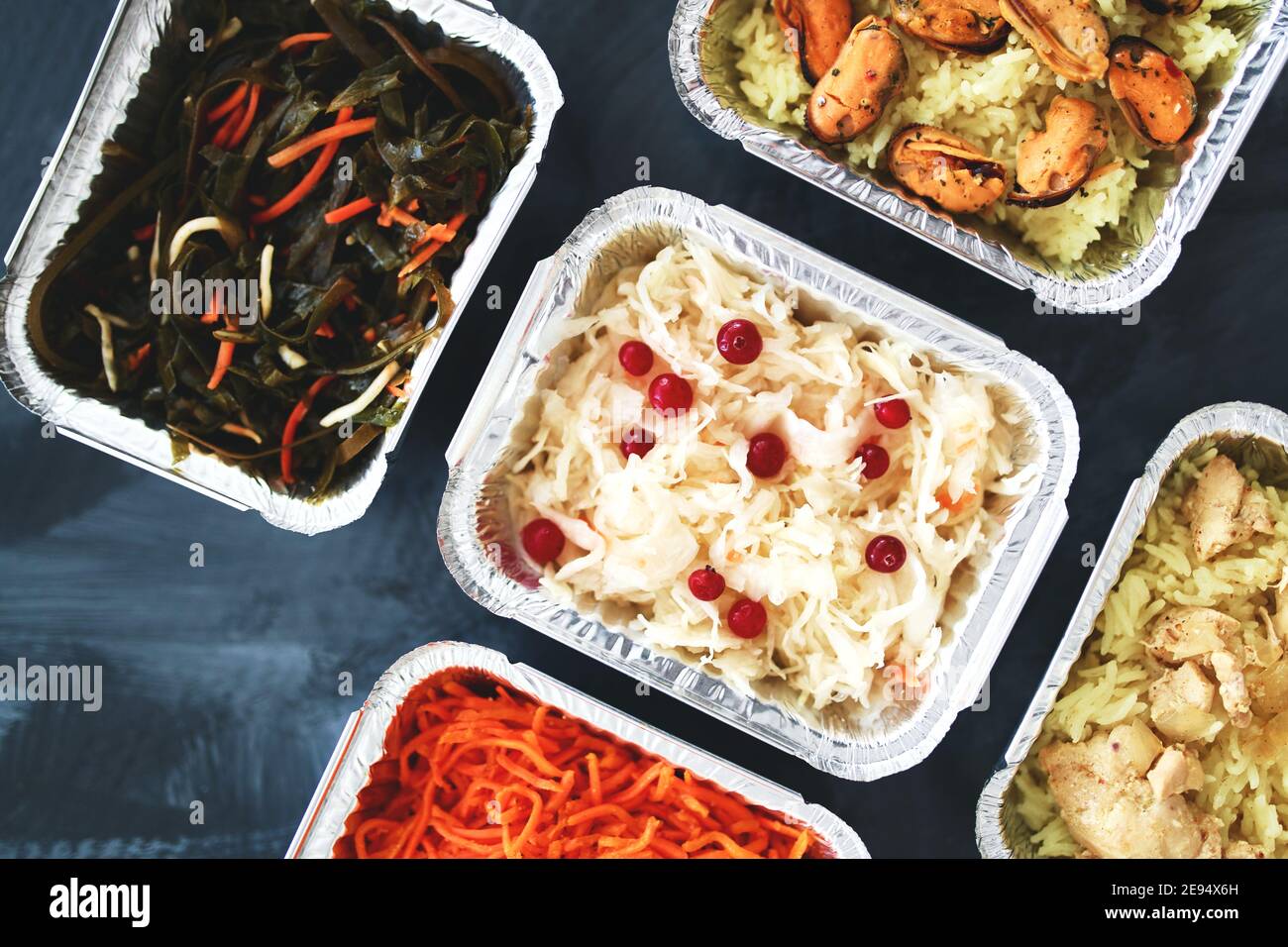 Different foil containers with delicious food Stock Photo - Alamy
