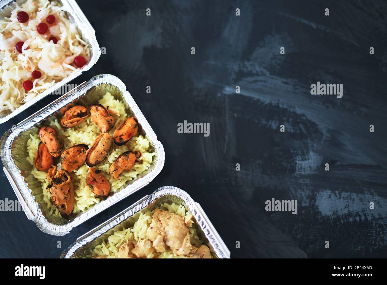 Different foil containers with delicious food Stock Photo - Alamy