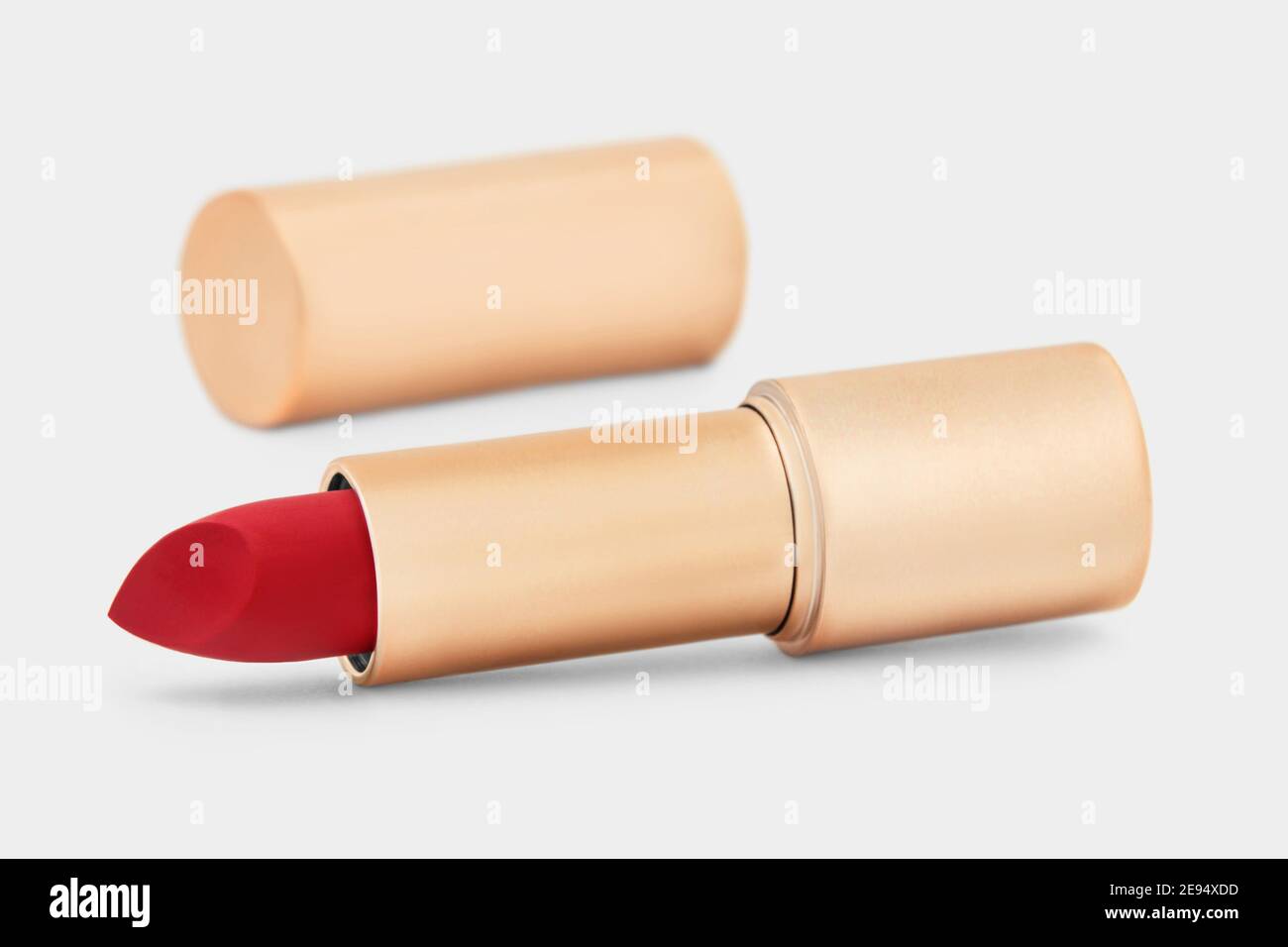 Red golden lipstick against white background Stock Photo - Alamy