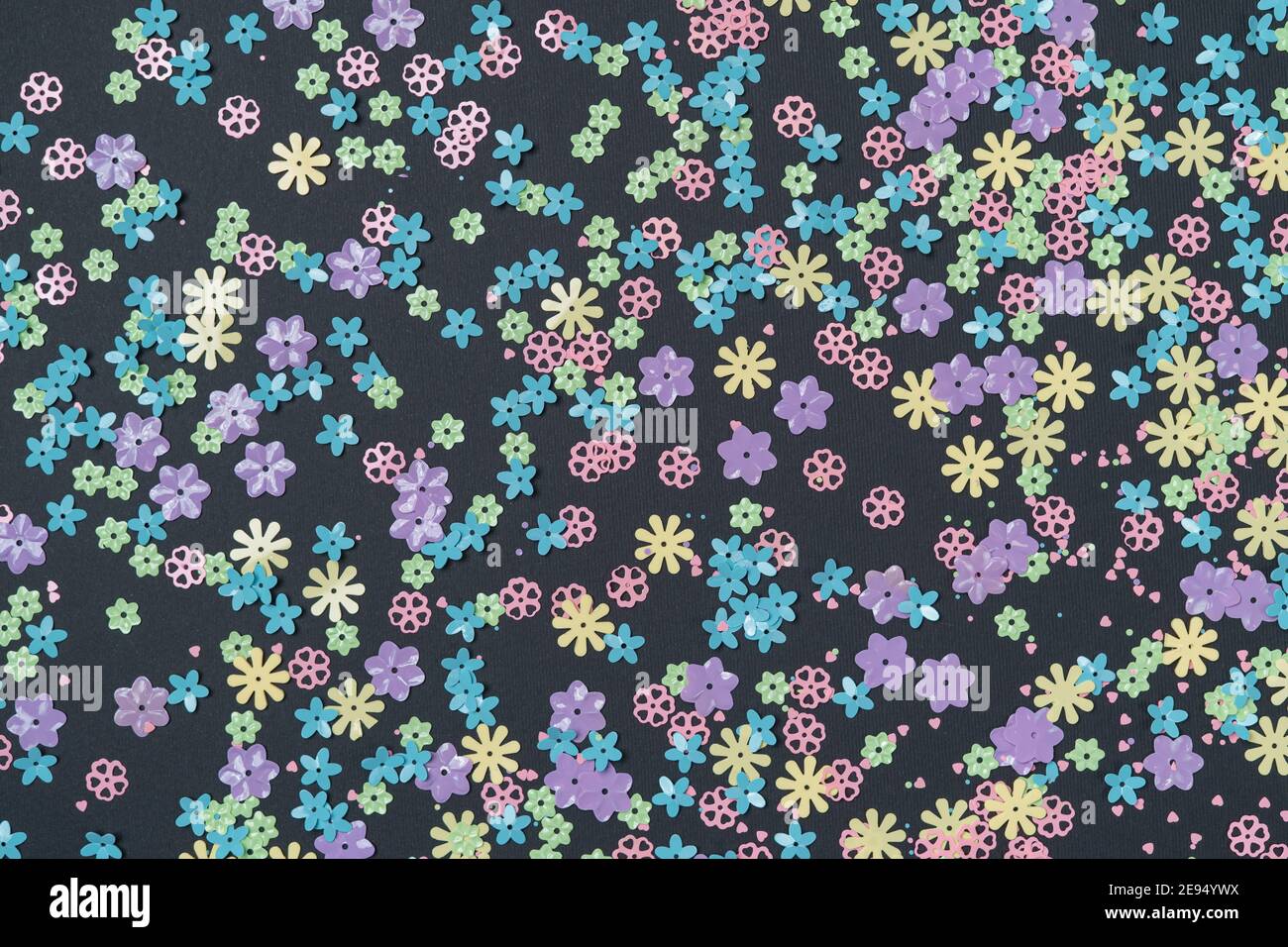 Festive black background with colorful flowers. Multi-colored small ...