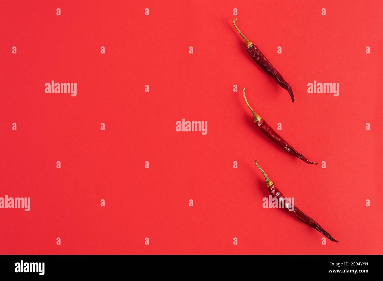 Dried red chili pepper on red background. Texture of isolated chili ...