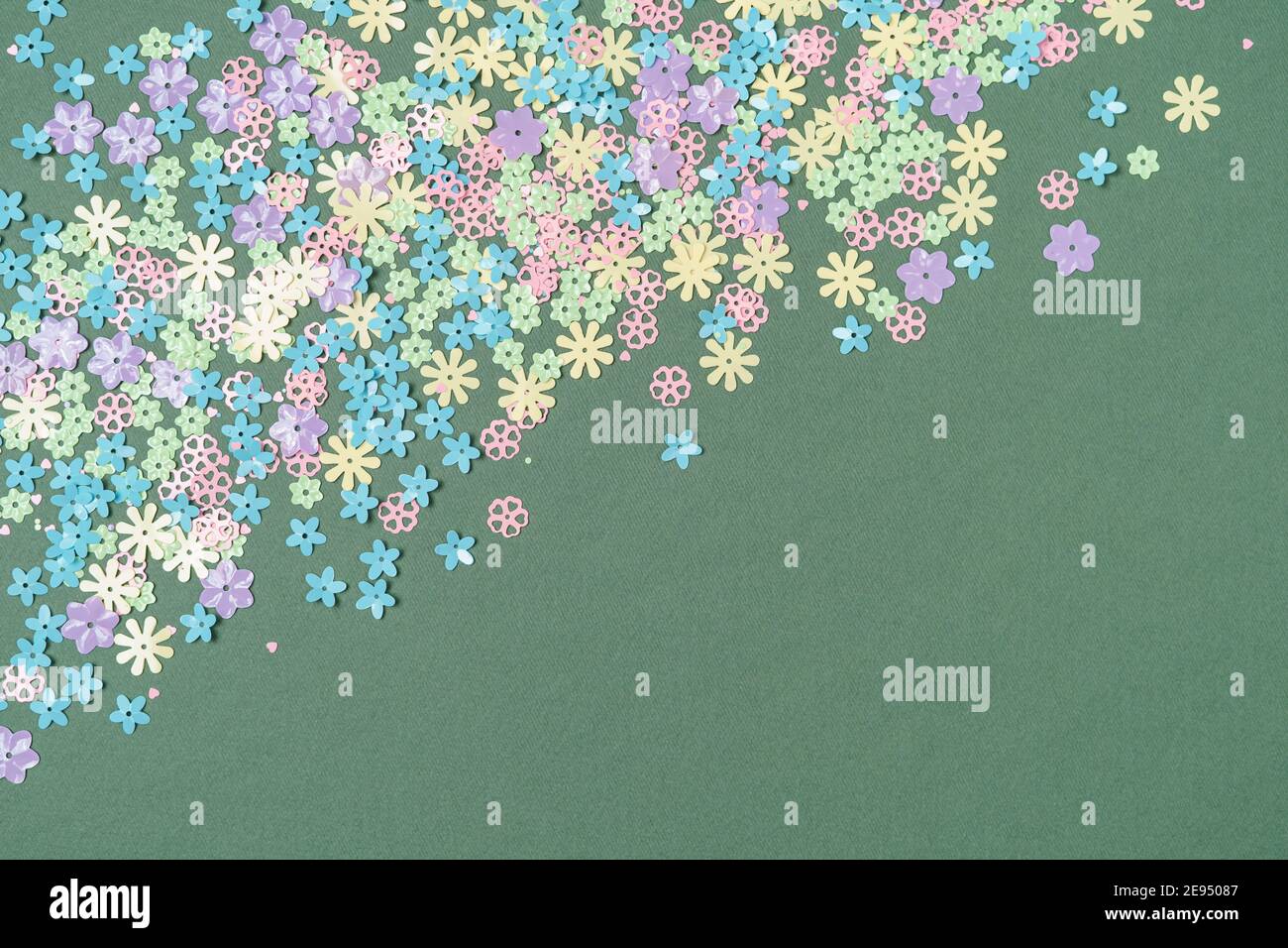 Festive green background with colorful flowers with copy space. Multi ...