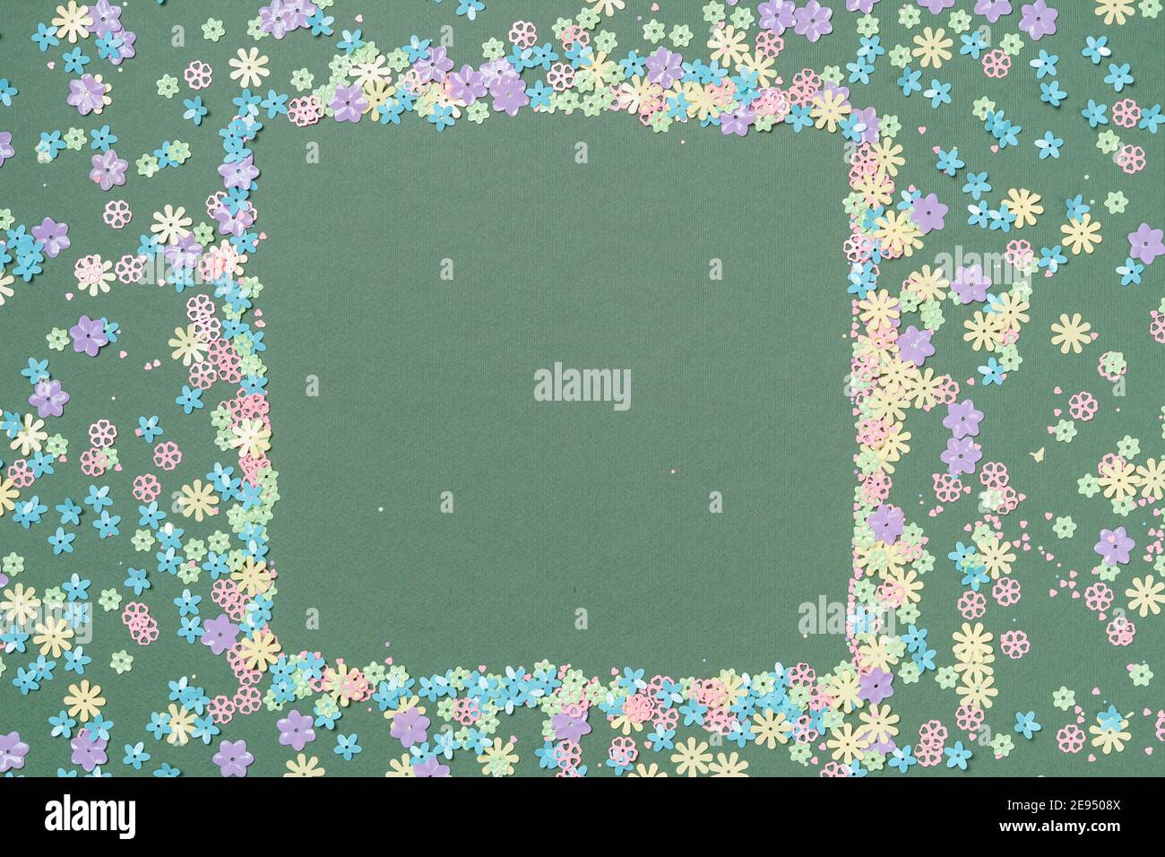 Festive green background with colorful flowers. Empty square with copy ...