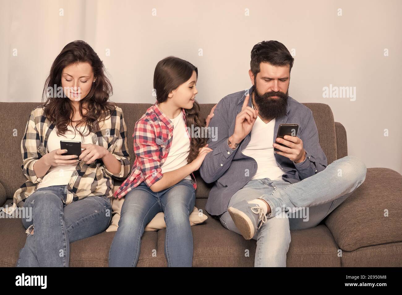 Online family meeting. Little child and parents use cellphones at home ...