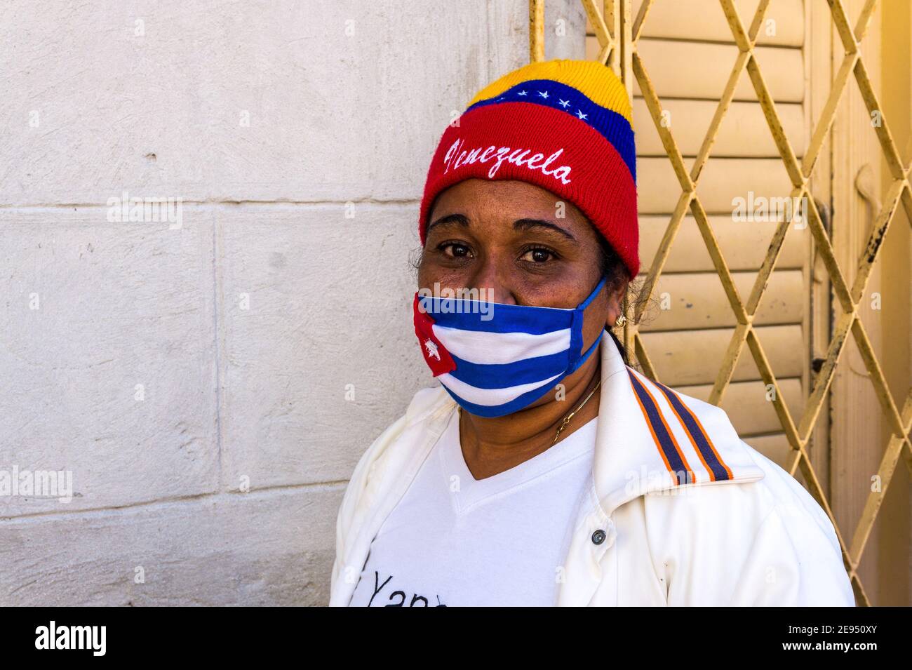 Cuban Afro-Caribbean woman wearing a protective face mask with the ...