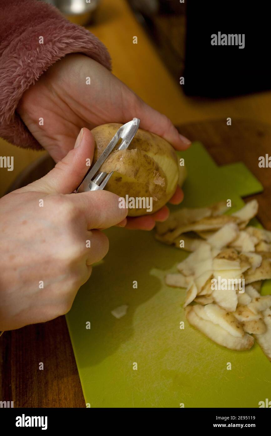 Woman cutting potato hi-res stock photography and images - Alamy