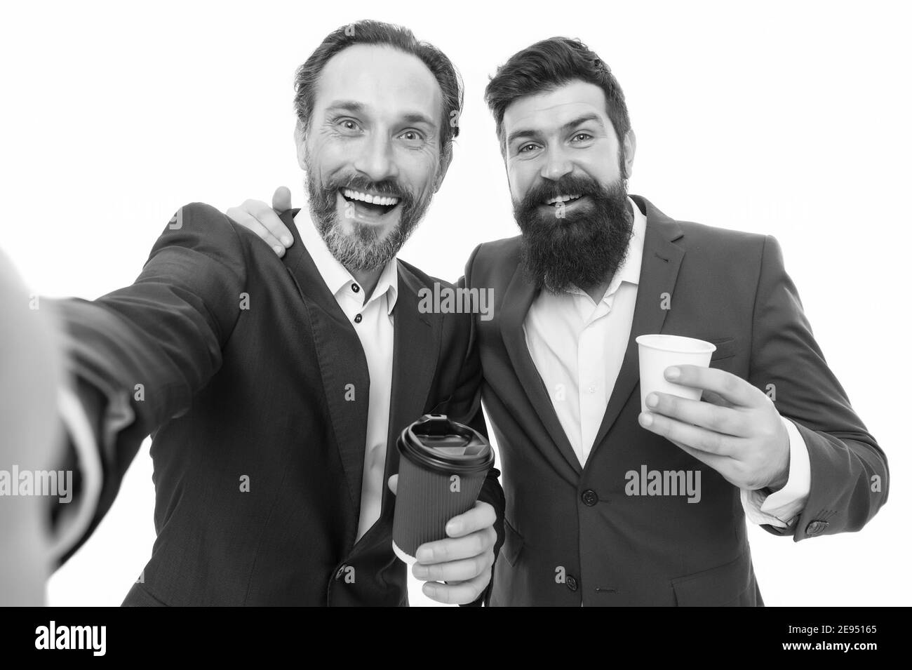 Do things faster with more energy. Happy businessmen hold cups of hot ...