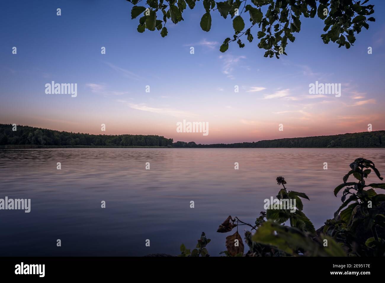 Amazing shot of a reflective lake on a beautiful sunset background ...