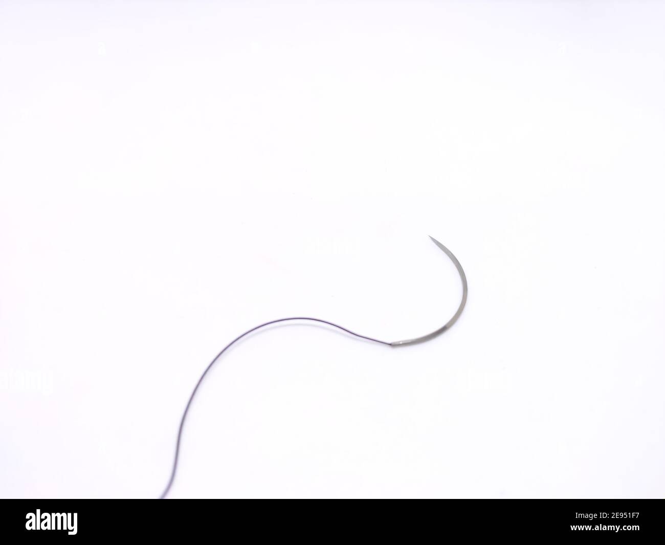 Closeup shot of a surgical suture material isolated on a white ...