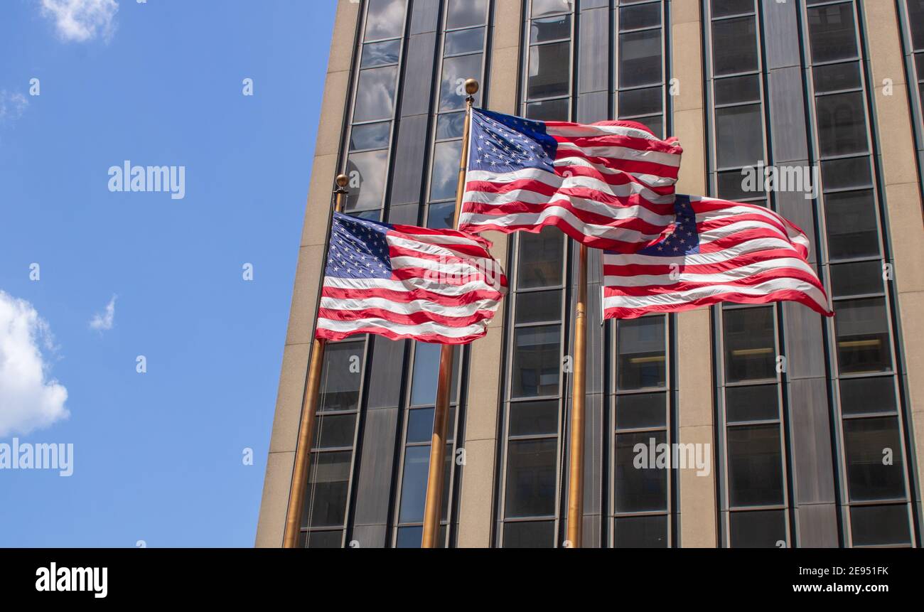 Waving stars and stripes in front of an skyscraper or office building ...