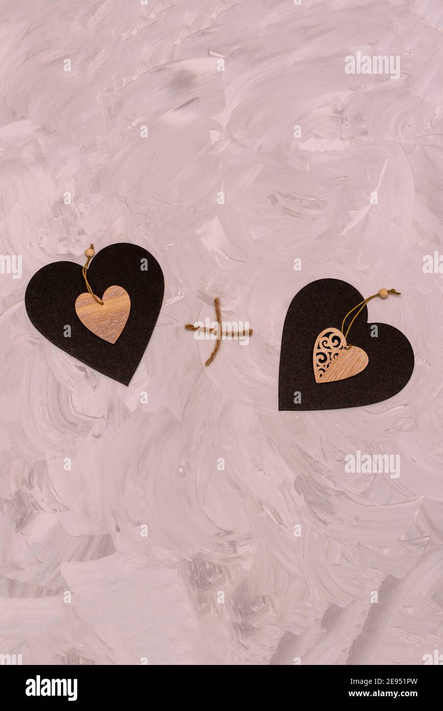 Two hearts made of graphite and wood on gray textured background. Heart ...