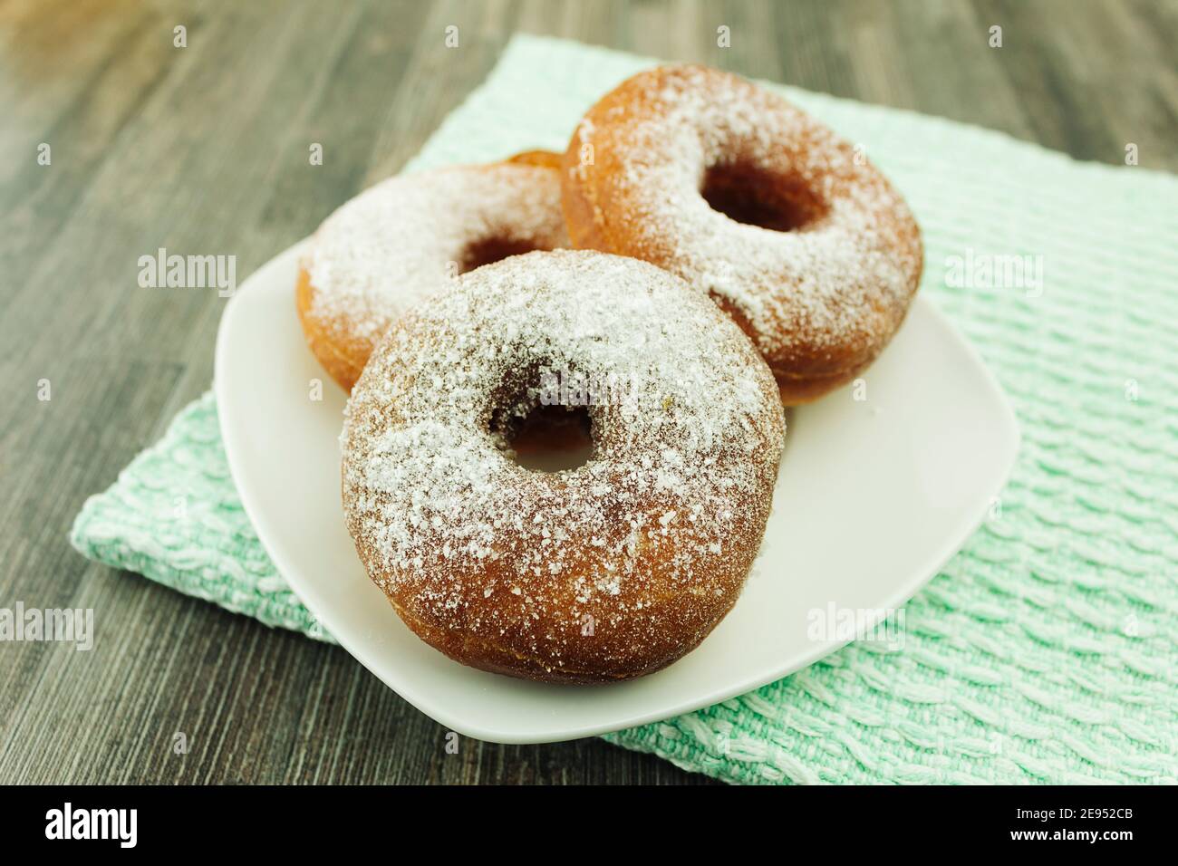 Round donuts on a square and white plate. Background with empty space ...