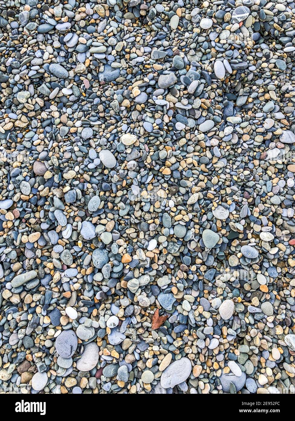 Overhead shot of small and colorful rocks spread all over the beach ...