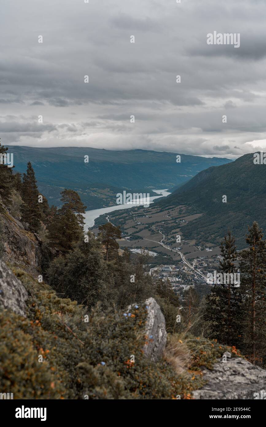 Vertical aerial shot of a mountains with a river flowing down in the ...