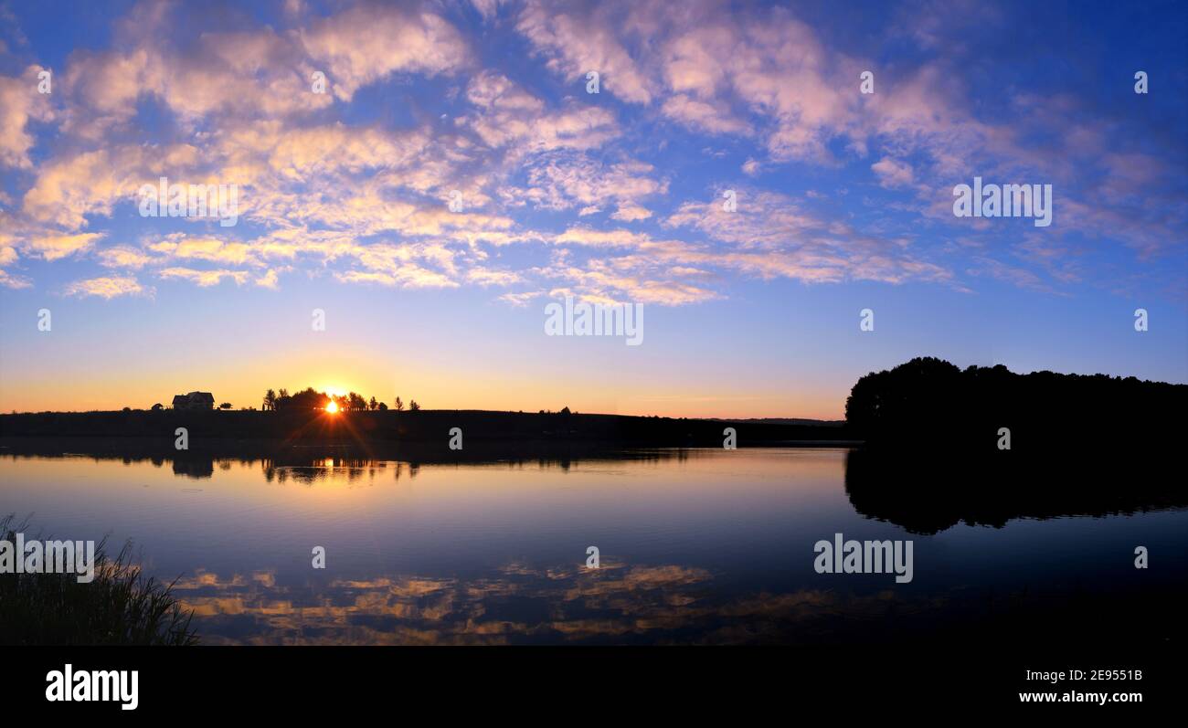 Amazing shot of a reflective lake on a beautiful sunset background ...