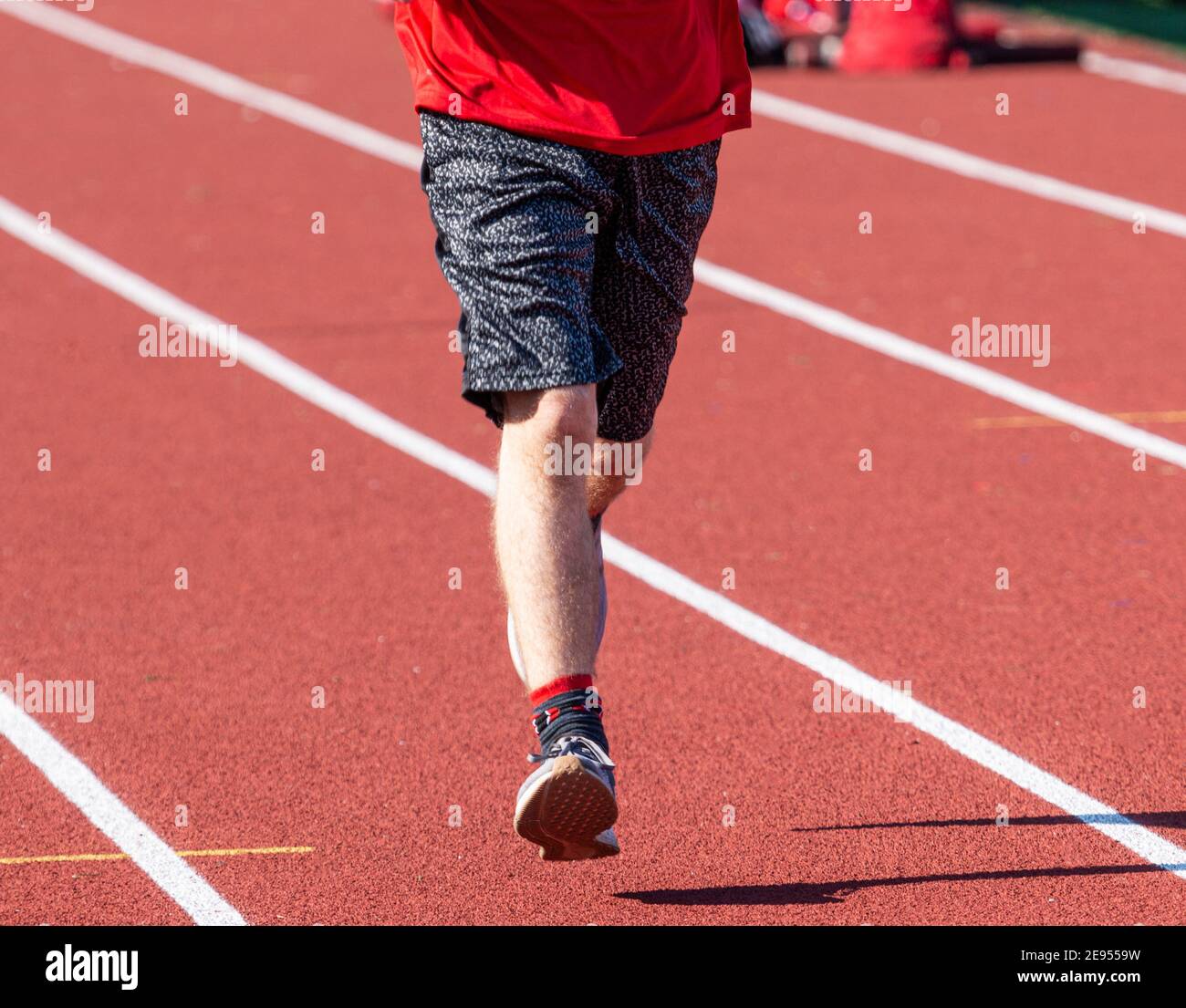 Front view of the lower half of a high school boys body running on a ...