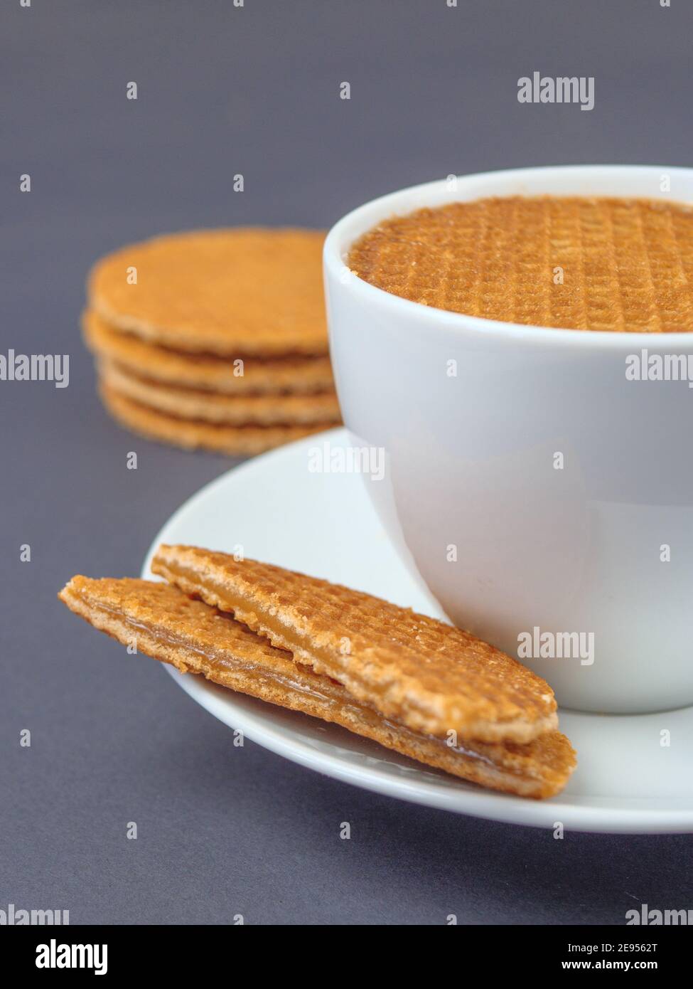 Traditional Dutch cookies Stroopwafels placed on a white saucer next to ...