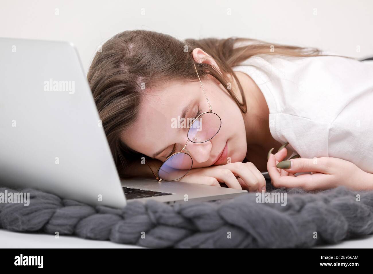 Sleeps in the workplace. Tired young woman working, headache, falling ...