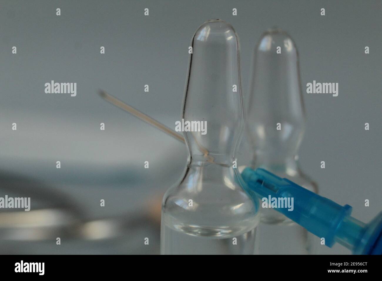 vaccination vaccination syringe with blue medicine liquid and vials ...