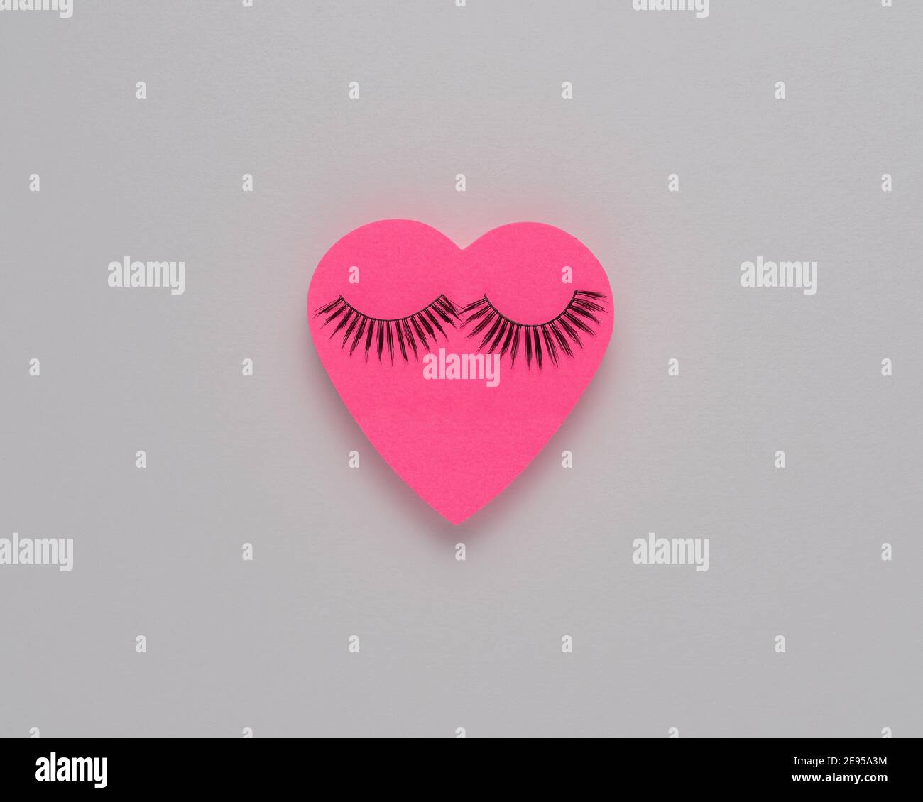 Heart shape pink paper with eyelashes. Valentines or woman's day ...