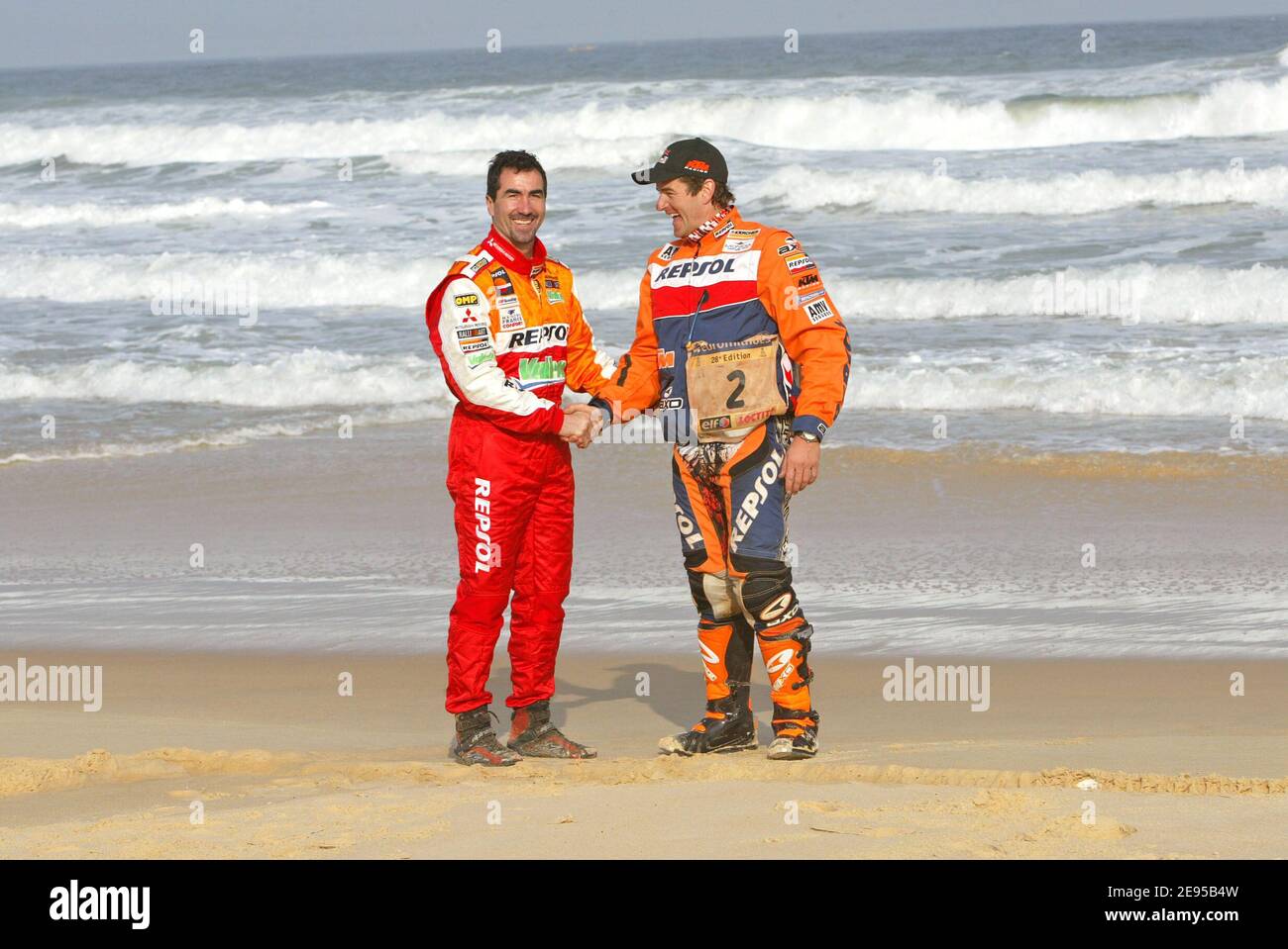 French driver Luc Alphand and Spanish bike rider Marc Coma celebrate ...